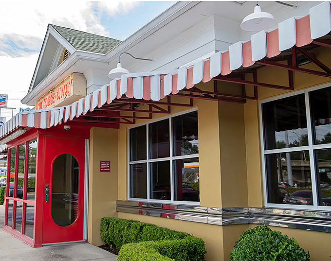 The iconic red and white awning of OK Cafe stands as a beacon of Southern comfort food in Atlanta's West Paces Ferry area.