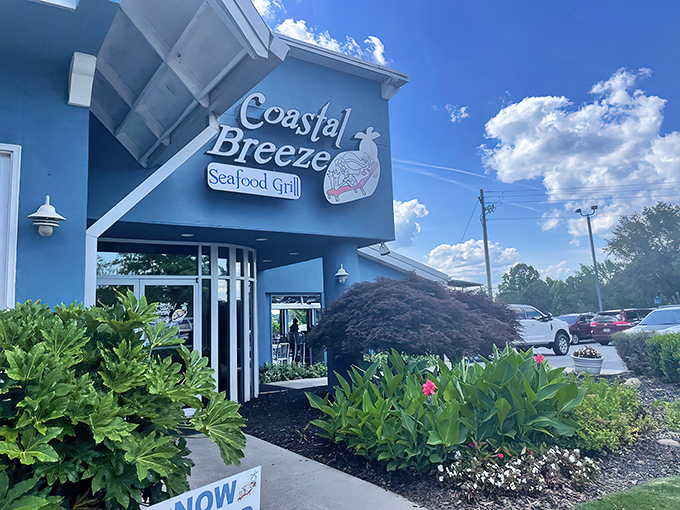 The bright blue exterior of Coastal Breeze stands out like a maritime mirage in landlocked Buford, promising seafood treasures within.