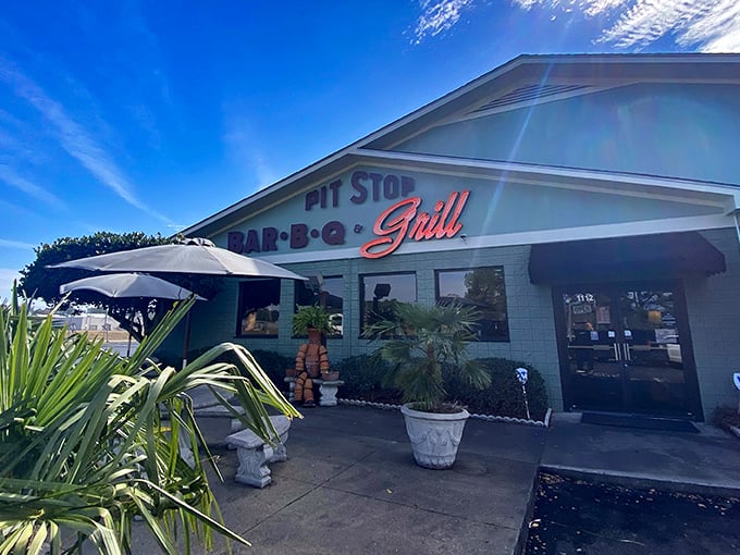 The mint-green sanctuary of smoke beckons from the roadside, with stone tables promising a moment of barbecue bliss before you even step inside.