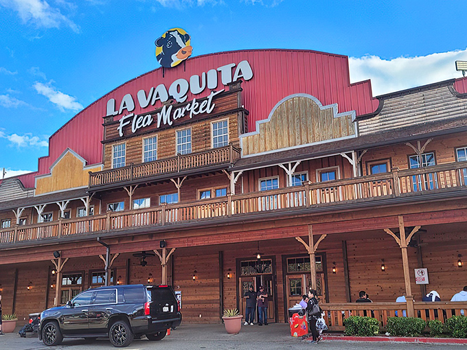 The iconic red-roofed facade of La Vaquita welcomes treasure hunters with its Western-style porch and watchful cartoon cow mascot overhead.