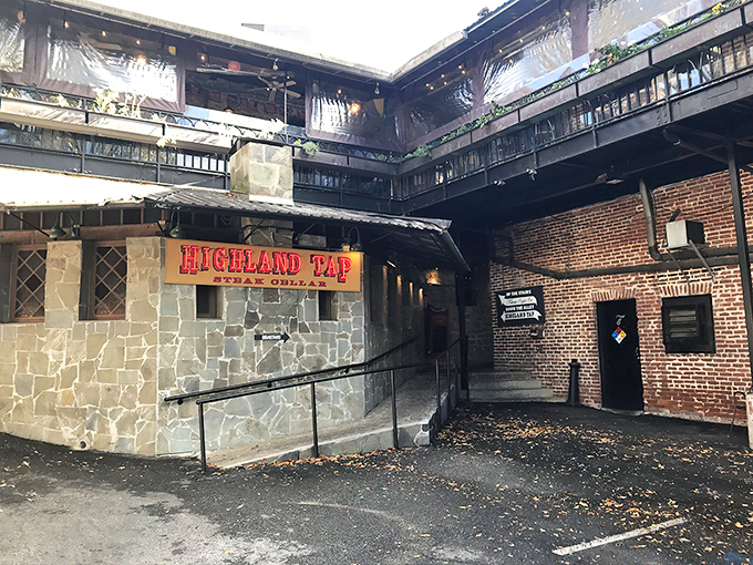 The entrance to Highland Tap beckons like a speakeasy from another era. Stone walls and that iconic burgundy awning promise carnivorous delights below street level.
