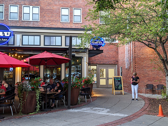 The iconic blue BRU sign beckons hungry patrons like a burger lighthouse on Mass Ave's brick-lined shores. Come for the burgers, stay for the patio vibes.