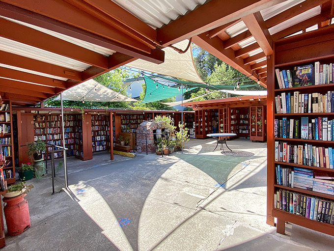 A literary wonderland unfolds beneath corrugated roofing, where signage guides bibliophiles through this open-air maze of knowledge.