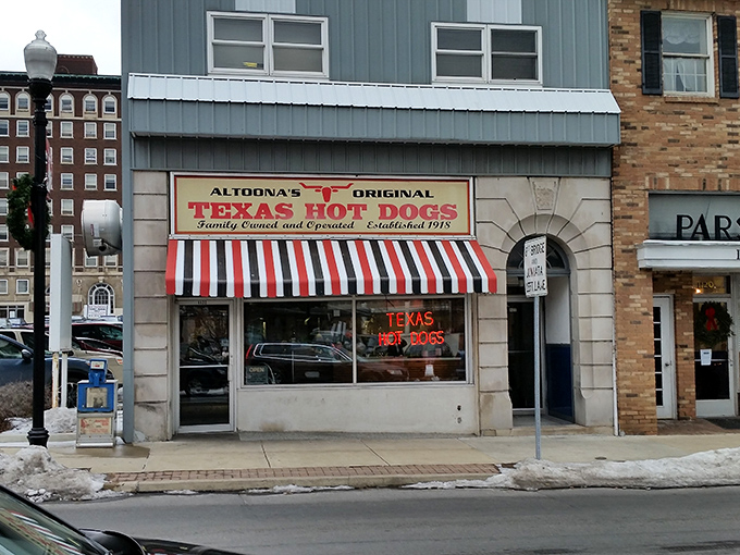 The iconic red and white striped awning of Texas Hot Dogs glows like a beacon for hungry travelers. A slice of Americana preserved on Altoona's 12th Avenue. 