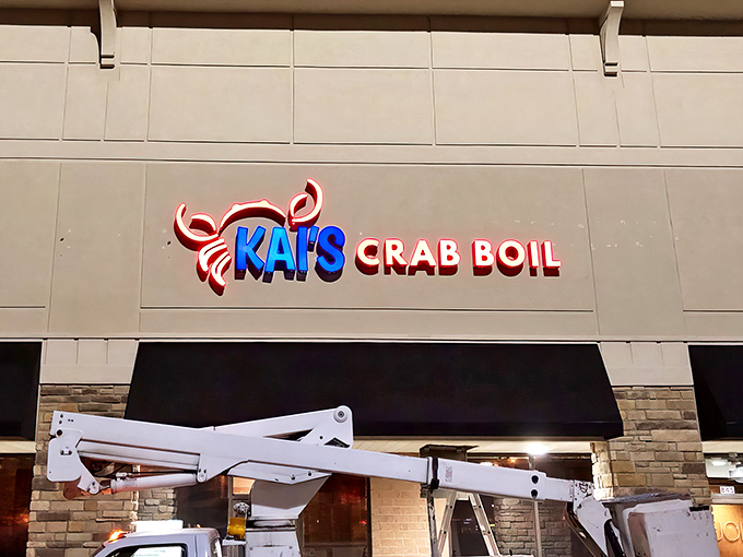 The bright neon sign of Kai's Crab Boil beckons seafood lovers like a lighthouse guiding hungry sailors to shore.