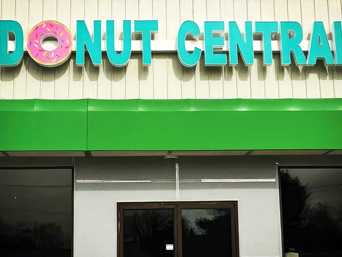 The teal and pink sign beckons like a sugar-coated lighthouse on the Columbus horizon. Donut Central's exterior promises sweet adventures within.