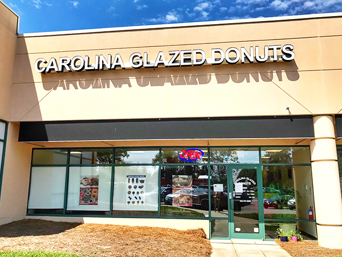 The unassuming storefront holds sweet treasures within. Like finding a $20 bill in old jeans, Carolina Glazed Donuts delivers unexpected joy.