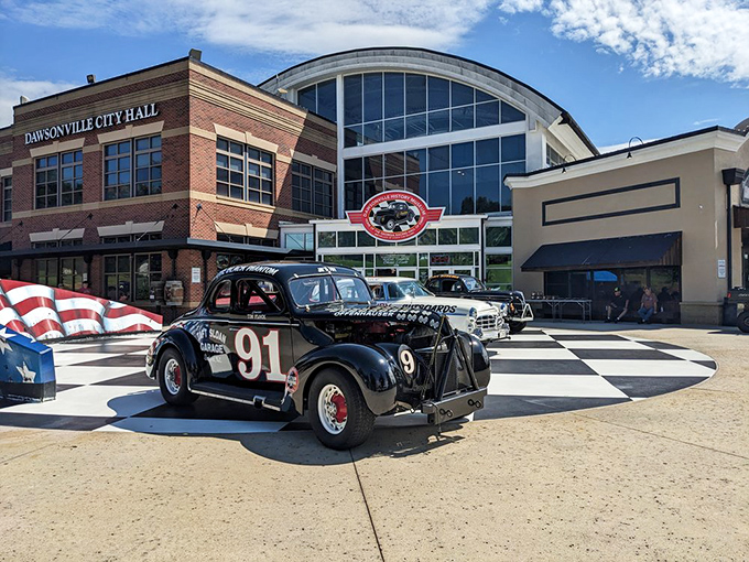 The checkered plaza welcomes speed enthusiasts like a starting line, with the sleek museum fa&ccedil;ade promising treasures that would make any gearhead's heart race faster than a qualifying lap.