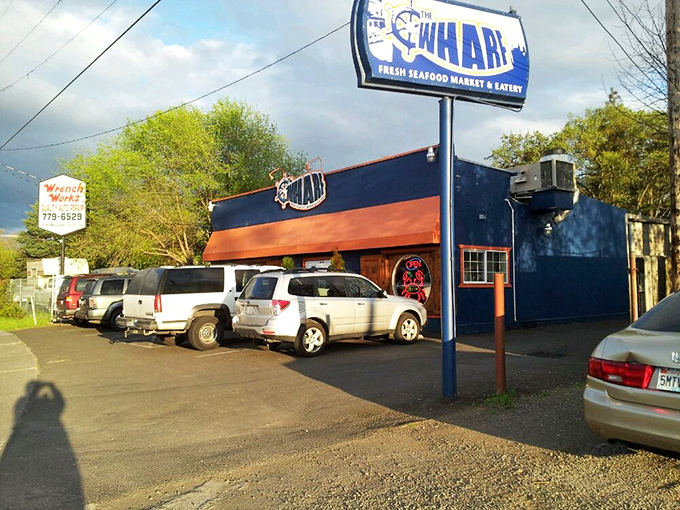 The bright blue exterior of The Wharf stands out like a maritime oasis in landlocked Medford, promising seafood treasures within those wooden-framed windows.