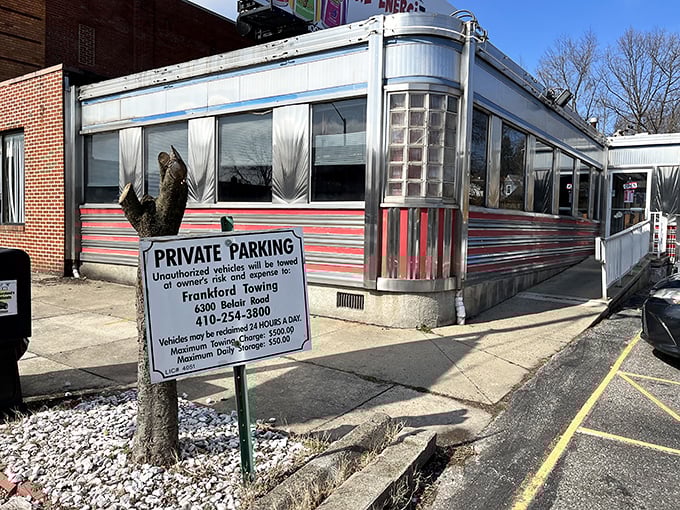 The gleaming stainless steel exterior of Overlea Diner shines like a time machine to the 1950s, complete with those iconic red stripes that practically scream "Come eat with us!"