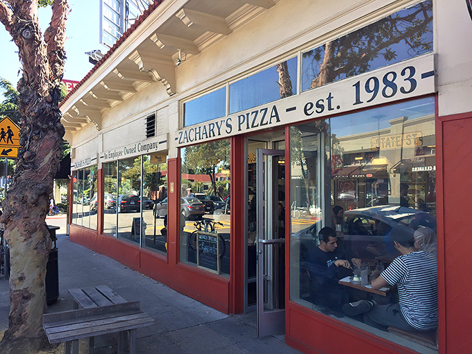 The corner storefront that launched a thousand cravings. Zachary's iconic Rockridge location glows like a beacon for pizza pilgrims after dark.
