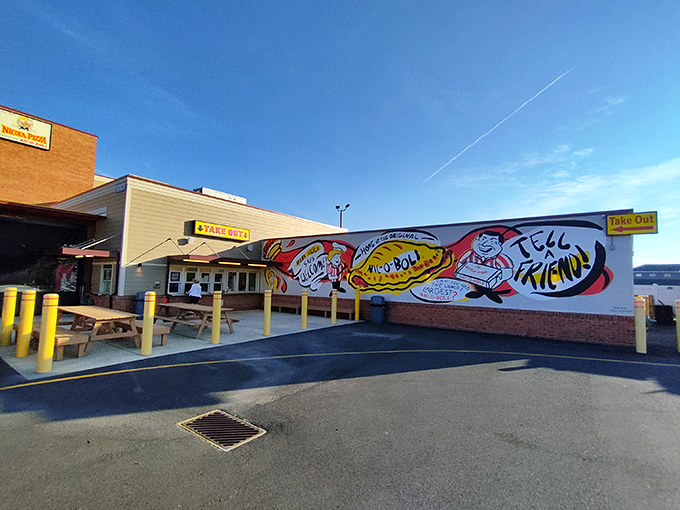 The iconic red and yellow awning of Nicola Pizza stands as a beacon of comfort food in Rehoboth Beach, promising culinary treasures within those brick walls.