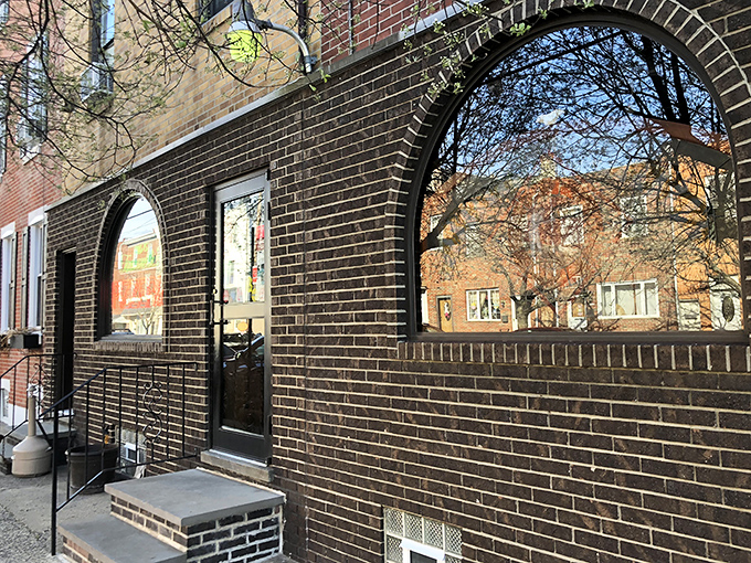 The neon glow of Tacconelli's sign beckons pizza pilgrims like a lighthouse for the carb-obsessed. Pizza paradise awaits behind that brick facade.