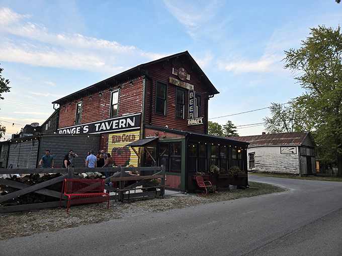The unassuming exterior of Bonge's Tavern stands like a culinary secret hiding in plain sight, its weathered red siding and humble signage belying the gastronomic treasures within.