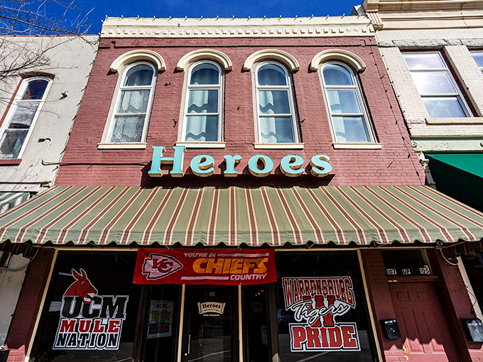 Heroes Restaurant & Pub stands like a culinary sentinel on Pine Street, its historic brick facade and turquoise sign promising comfort and satisfaction within.