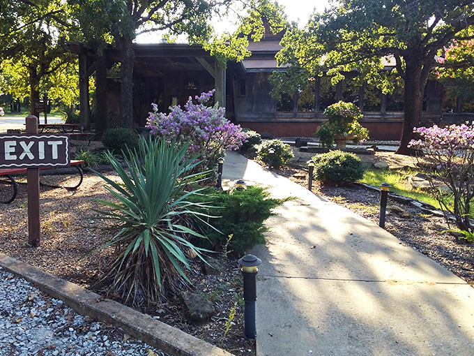 A garden path that promises culinary treasures ahead. Fireside Dining's entrance combines rustic charm with Oklahoma hospitality, inviting you to slow down and savor what's coming.
