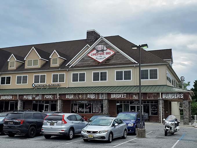 The rustic exterior of Limestone BBQ and Bourbon beckons like a smoke signal to hungry travelers. Corrugated metal and warm wood promise authentic barbecue treasures within.