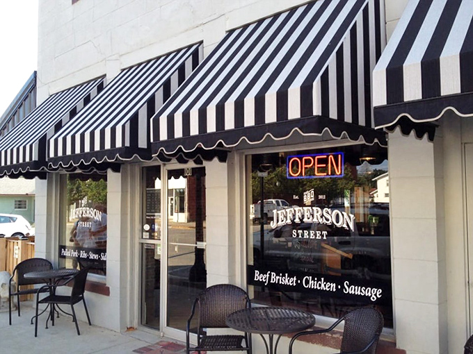 The classic black exterior with striped awnings isn't just charming&mdash;it's a beacon calling to barbecue pilgrims from across Indiana. Small-town magic with big-time flavor.