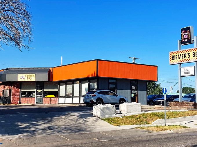 The bright orange exterior of Biemer's BBQ stands like a beacon of hope for hungry travelers. This unassuming building houses smoky treasures that draw pilgrims from across Kansas.