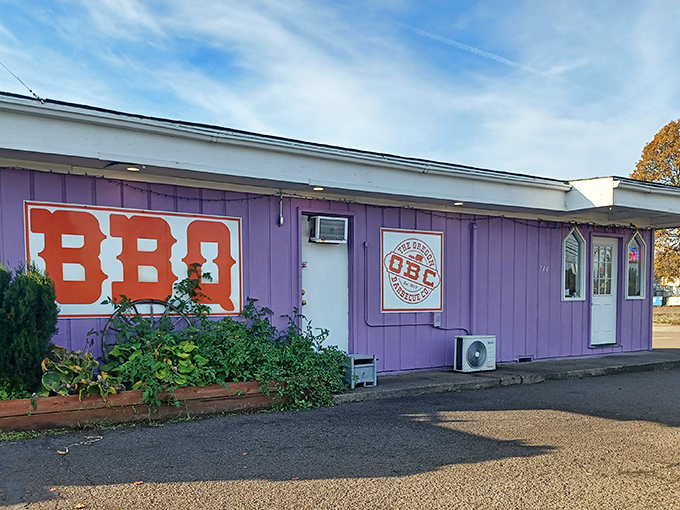 The unmistakable purple exterior of Oregon Barbecue Company stands out like a beacon for hungry travelers, promising smoky delights within.