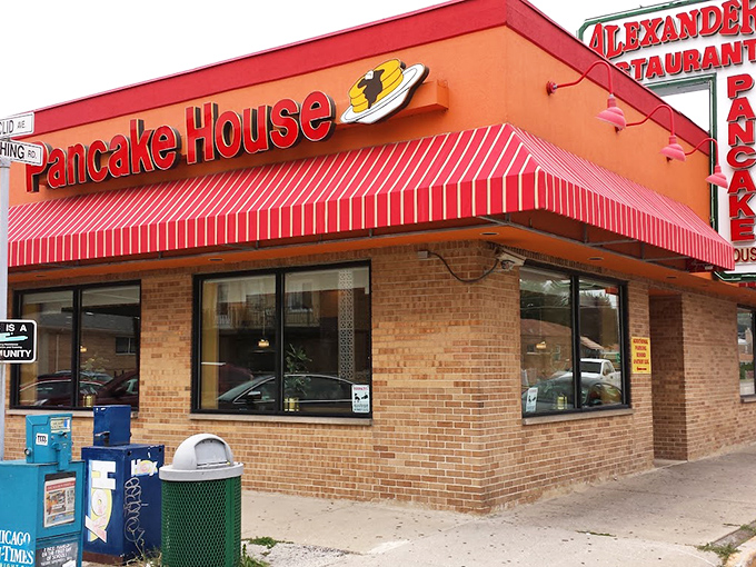 The iconic red awning of Alexander's stands out like a breakfast lighthouse, beckoning hungry travelers with its promise of pancake perfection.