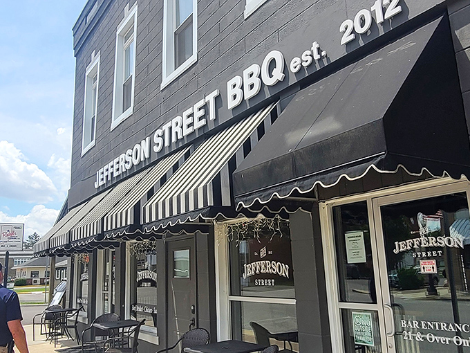 The classic black exterior with striped awnings isn't just charming&mdash;it's a beacon calling to barbecue pilgrims from across Indiana. Small-town magic with big-time flavor.