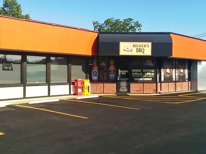 The bright orange exterior of Biemer's BBQ stands like a beacon of hope for hungry travelers. This unassuming building houses smoky treasures that draw pilgrims from across Kansas.