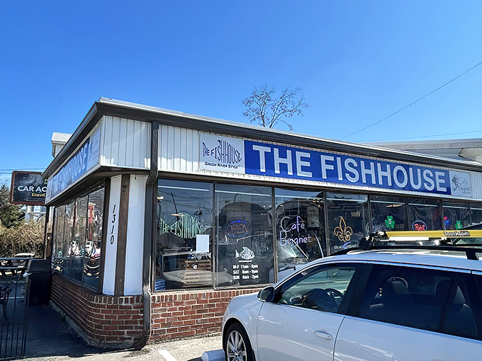 The unassuming exterior of The Fish House belies the seafood treasures within. Blue signage and simple storefront&mdash;culinary magic happens here. 