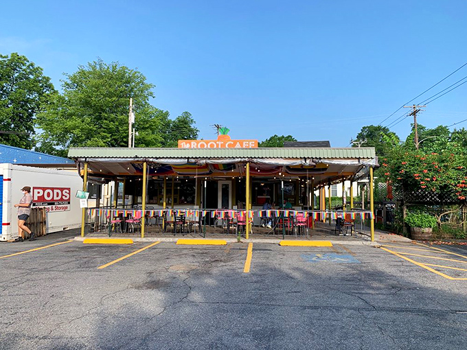 The unassuming exterior of The Root Cafe, where culinary magic hides behind a modest facade topped with that iconic carrot sign.