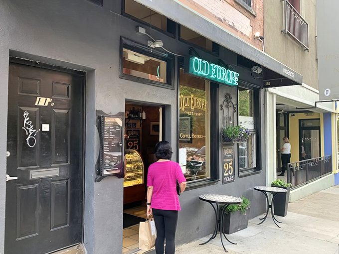 The blue neon glow of Old Europe's storefront beckons like a lighthouse for sugar-seekers in downtown Asheville. A quarter-century of sweet tradition awaits inside. 
