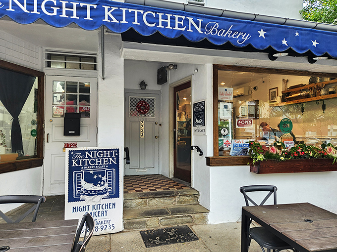 The blue awning beckons like a dessert lighthouse guiding sweet-toothed sailors home. Chestnut Hill's charming Night Kitchen Bakery promises delicious adventures ahead. 