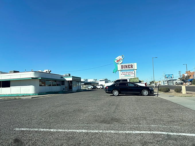 The classic roadside silhouette of Mel's Diner stands proudly against Arizona's impossibly blue sky, a time capsule of Americana waiting to welcome hungry travelers.