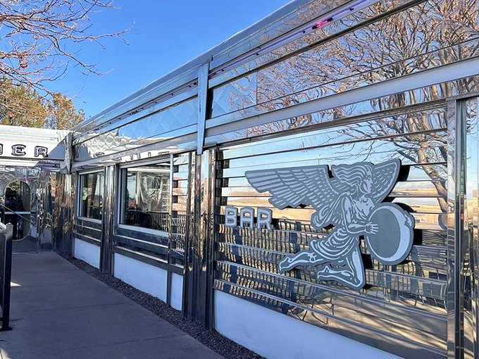The classic silver exterior of Moonlight Diner gleams in the Colorado sunshine, a chrome time capsule promising comfort food and nostalgia just steps from Denver International Airport.