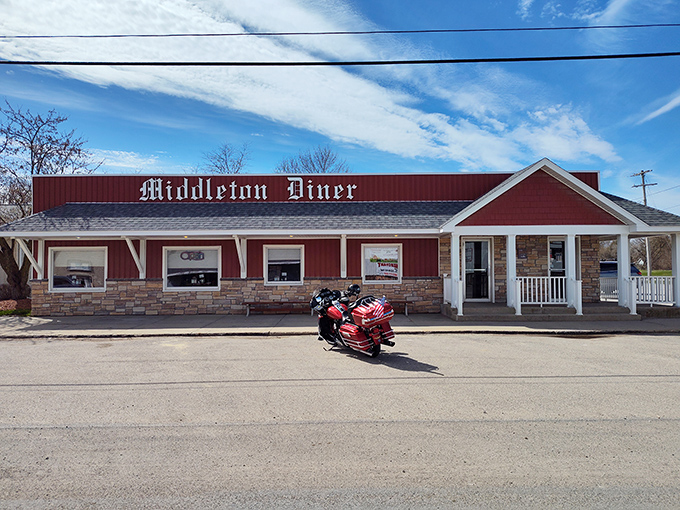 The classic red exterior of Middleton Diner stands like a beacon of comfort food promise against Michigan's ever-changing skies.