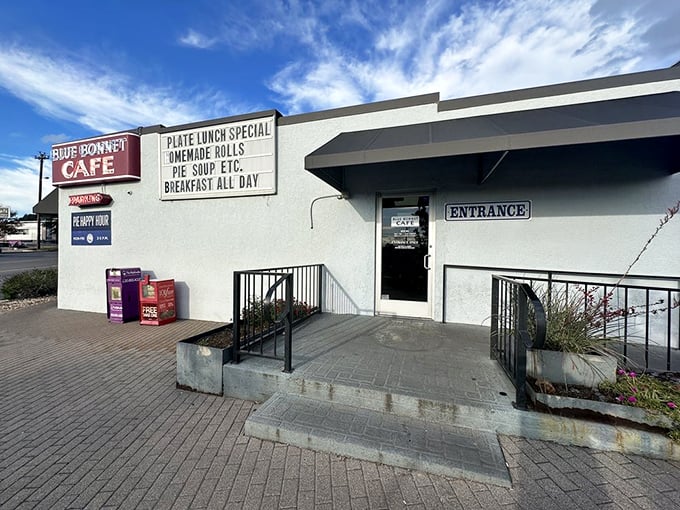 The white exterior with its classic blue and red signage isn't just a restaurant facade—it's a promise of comfort that's been kept for generations of Texans.