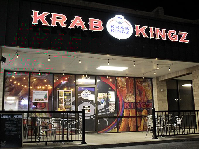 The bright red Krab Kingz sign glows like a beacon in the night, promising seafood treasures within this unassuming strip mall location.