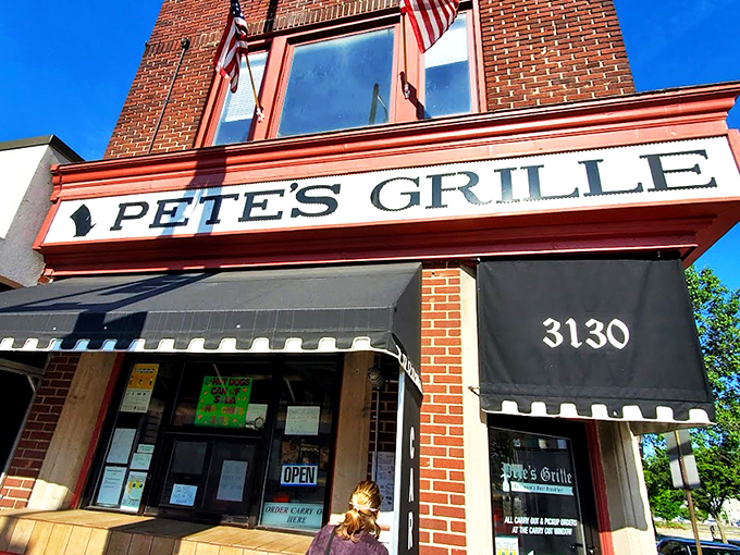 The unassuming brick facade of Pete's Grille stands like a breakfast beacon on Greenmount Avenue, promising honest food without the frills.