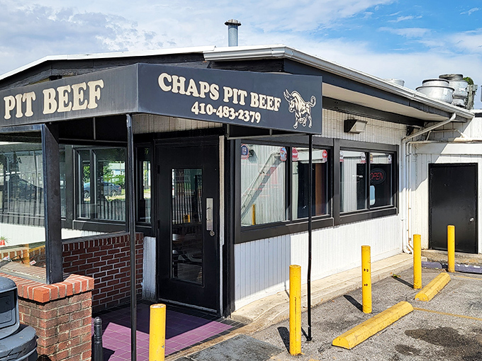 The unassuming exterior of Chaps Pit Beef stands like a beacon for barbecue pilgrims. The cartoon sign reminds you this is a destination worth driving to.