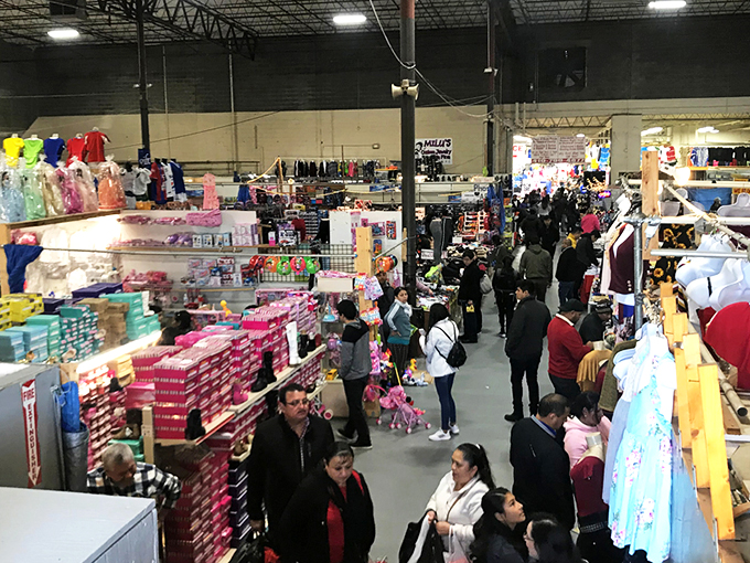 The indoor treasure hunt begins! Crowds navigate this labyrinth of bargains where one person's castoffs become another's prized possessions.
