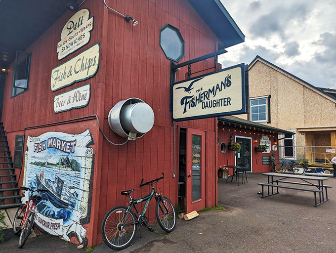 The little red fish shack that could! The Fisherman's Daughter stands proudly on Grand Marais' harbor, promising seafood treasures within its humble walls.