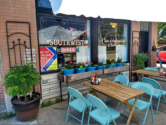 The unassuming brick exterior hides a southwestern flavor explosion within, where the patio's colorful chairs hint at the vibrancy waiting inside. 