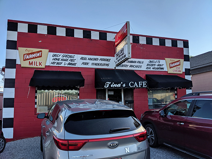 The red and white checkered facade of Tina's Cafe stands like a culinary lighthouse, beckoning hungry travelers with promises of homemade comfort.