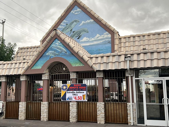 The iconic dolphin mural on Mariscos Altamar's exterior promises an ocean of flavor in the high desert. A seafood mirage that actually delivers.