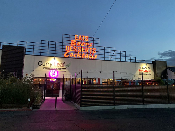 The neon sign beckons like a lighthouse for hungry souls&mdash;Curry Leaf's exterior glows with promise as dusk settles over Albuquerque.