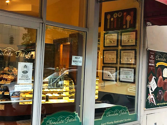 The storefront beckons like a chocolate siren, with award certificates proudly displayed. Resistance is futile&mdash;just look at that "OPEN" sign glowing with promise.