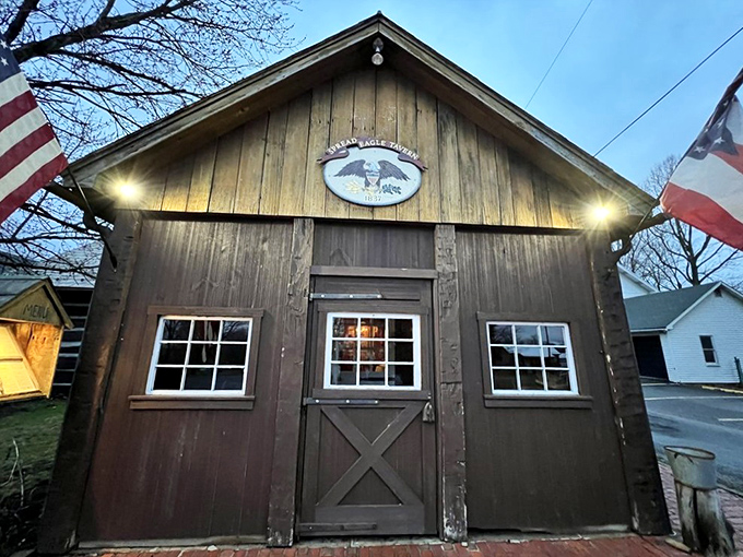 The Spread Eagle Tavern glows like a welcoming beacon in the night, its historic charm beckoning hungry travelers with promises of culinary delights within.