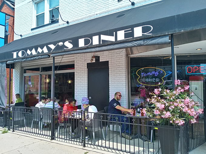 Tommy's Diner stands like a time capsule on West Broad Street, its classic black awning and white brick promising honest-to-goodness comfort inside.
