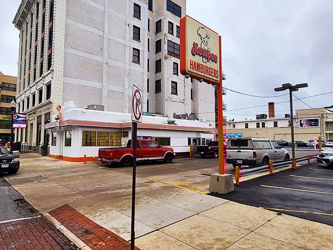 The iconic Kewpee exterior stands like a time capsule in downtown Lima, complete with its signature doll mascot keeping watch over hungry visitors.