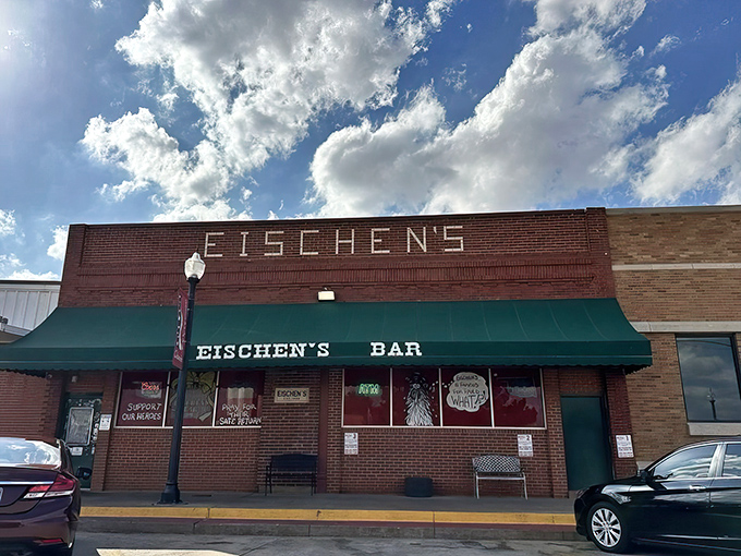The unassuming brick façade of Eischen's Bar stands like a culinary lighthouse in Okarche, beckoning hungry travelers with its iconic green awning.