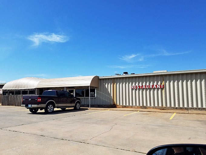 The unassuming exterior of Ken's Steak and Ribs proves the old adage: never judge a restaurant by its corrugated metal siding. Culinary treasures often hide in plain sight.